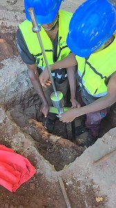 Performing Dynamic Cone Penetration (DCP) Test during a Structural Audit via Non Destructive Testing (NDT) exercise of an existing building. The aim is to establish the engineering properties of the soils on site on which the foundations are built on. The main output will be "The Numeric Value of Soil Bearong Capacity" to be used to assess the capacity of the existing foundations Captured in the footage is an active structural retrofit site in Ukunda- Diani🇰🇪 code named Project Flying Dutchman